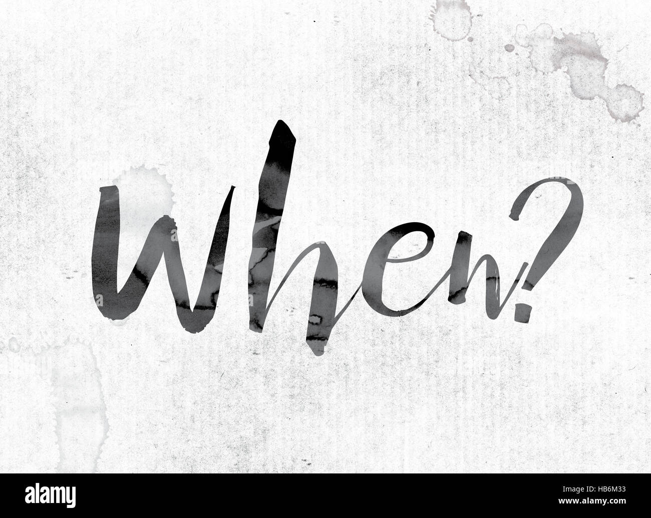 The word "When" concept and theme painted in watercolor ink on a white ...
