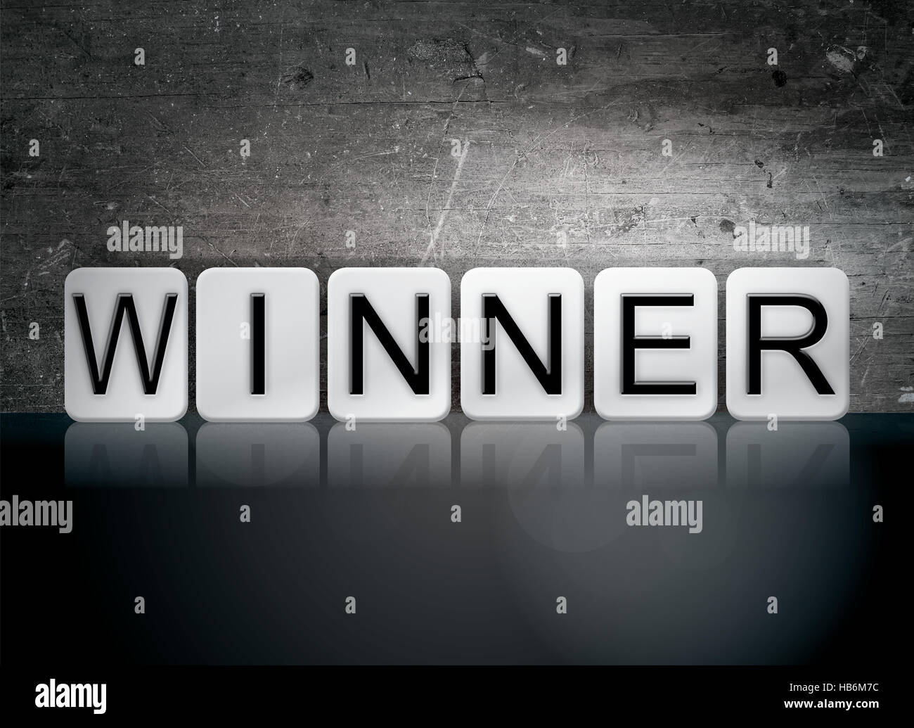 The word "Winner" written in white tiles against a dark vintage grunge ...