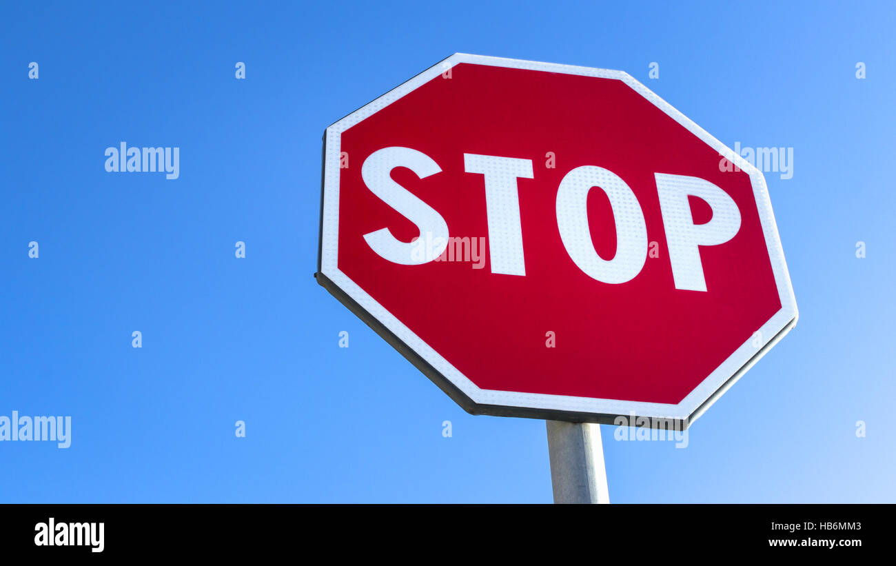 Red stop road sign and blue sky Stock Photo - Alamy