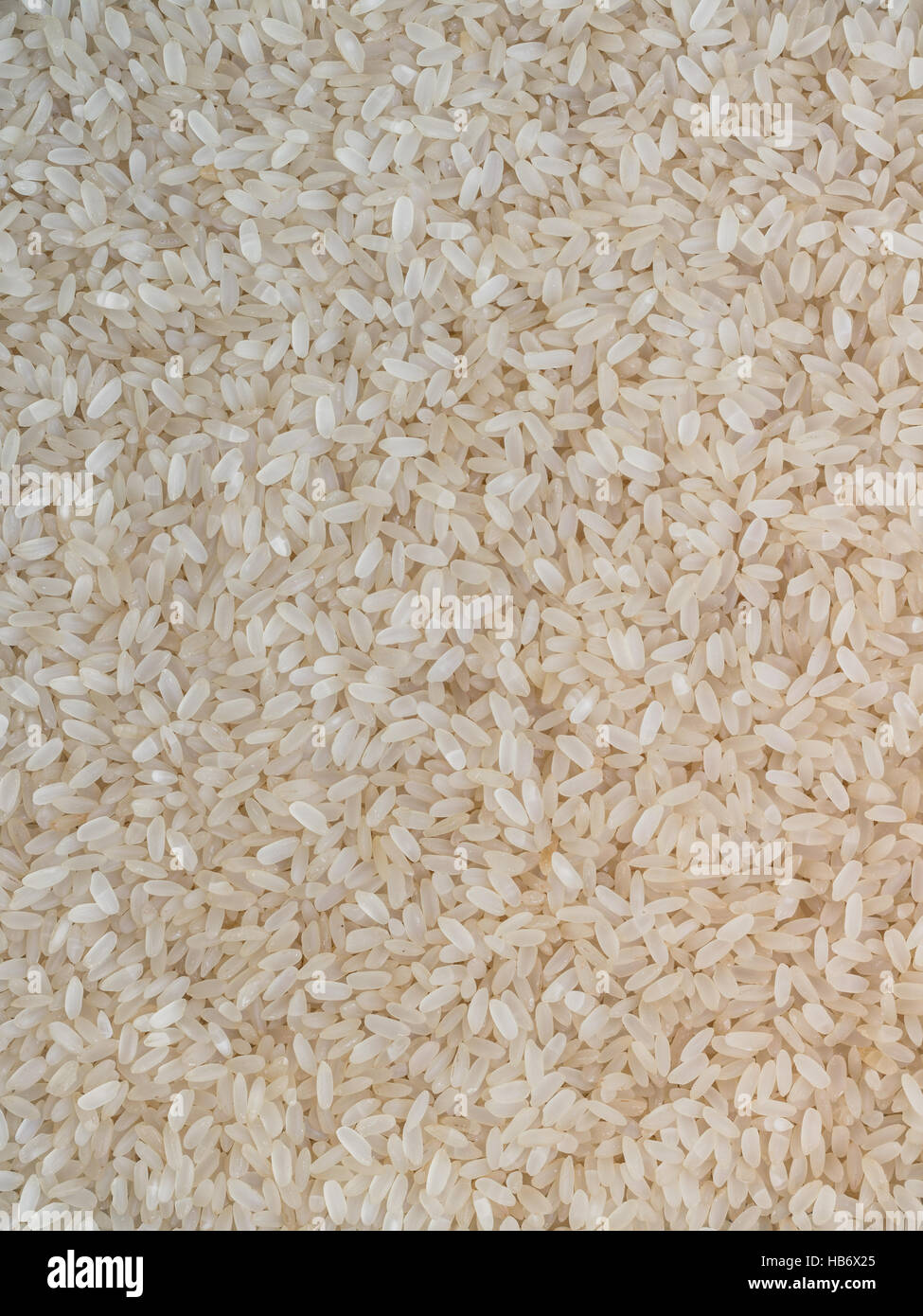 Uncooked rice background Stock Photo - Alamy