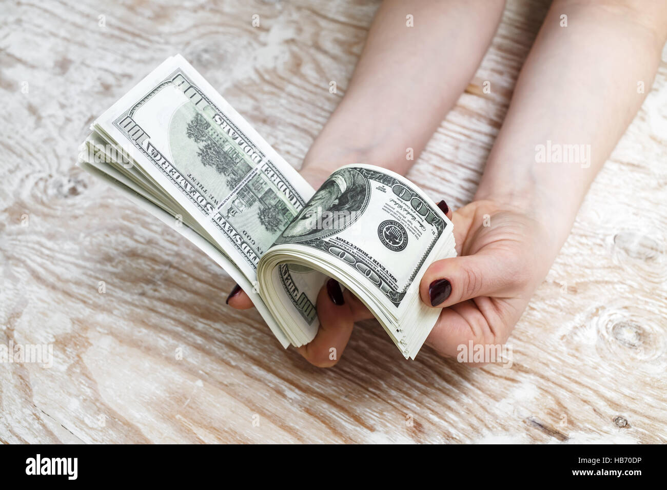 Woman counting dollars hi-res stock photography and images - Alamy