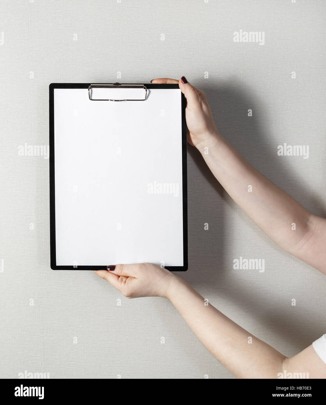 Clipboard in female hands Stock Photo - Alamy