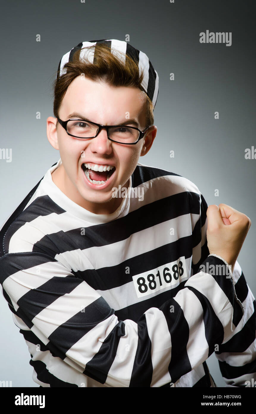 Funny prisoner in prison concept Stock Photo - Alamy