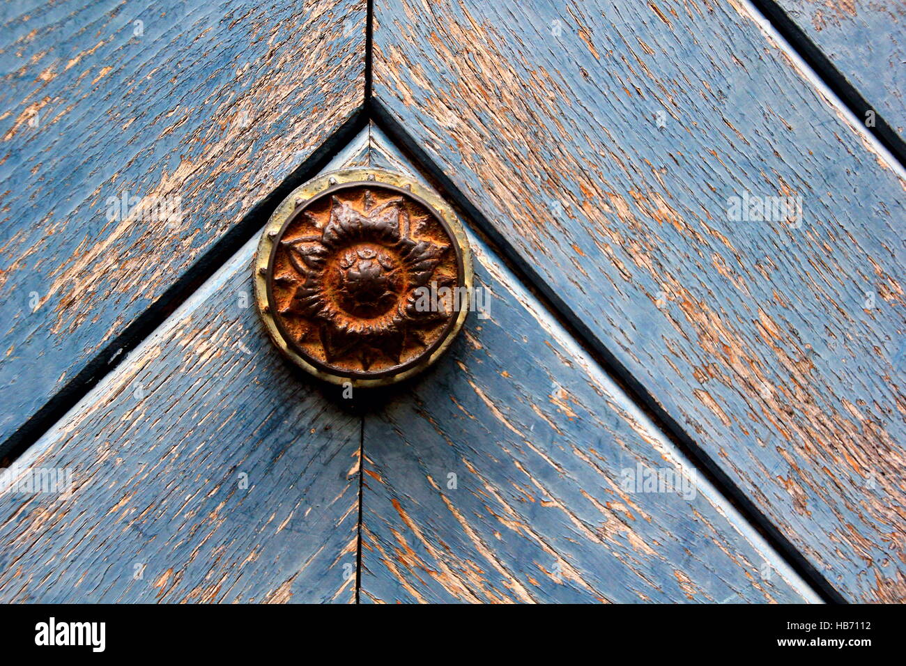 Rustic door knob on a blue weathered door Stock Photo - Alamy