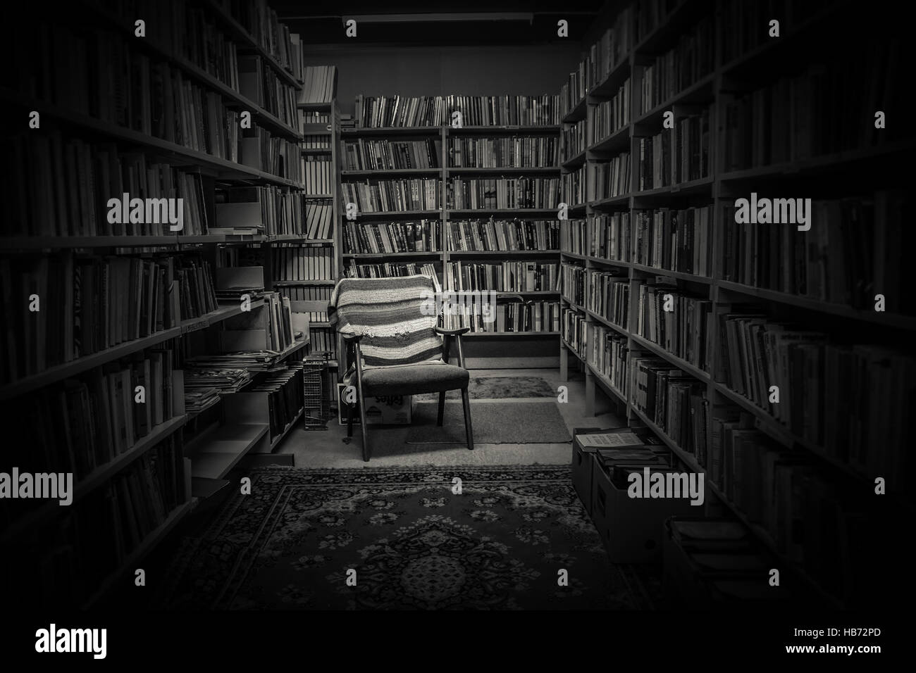 old chair between books Stock Photo - Alamy