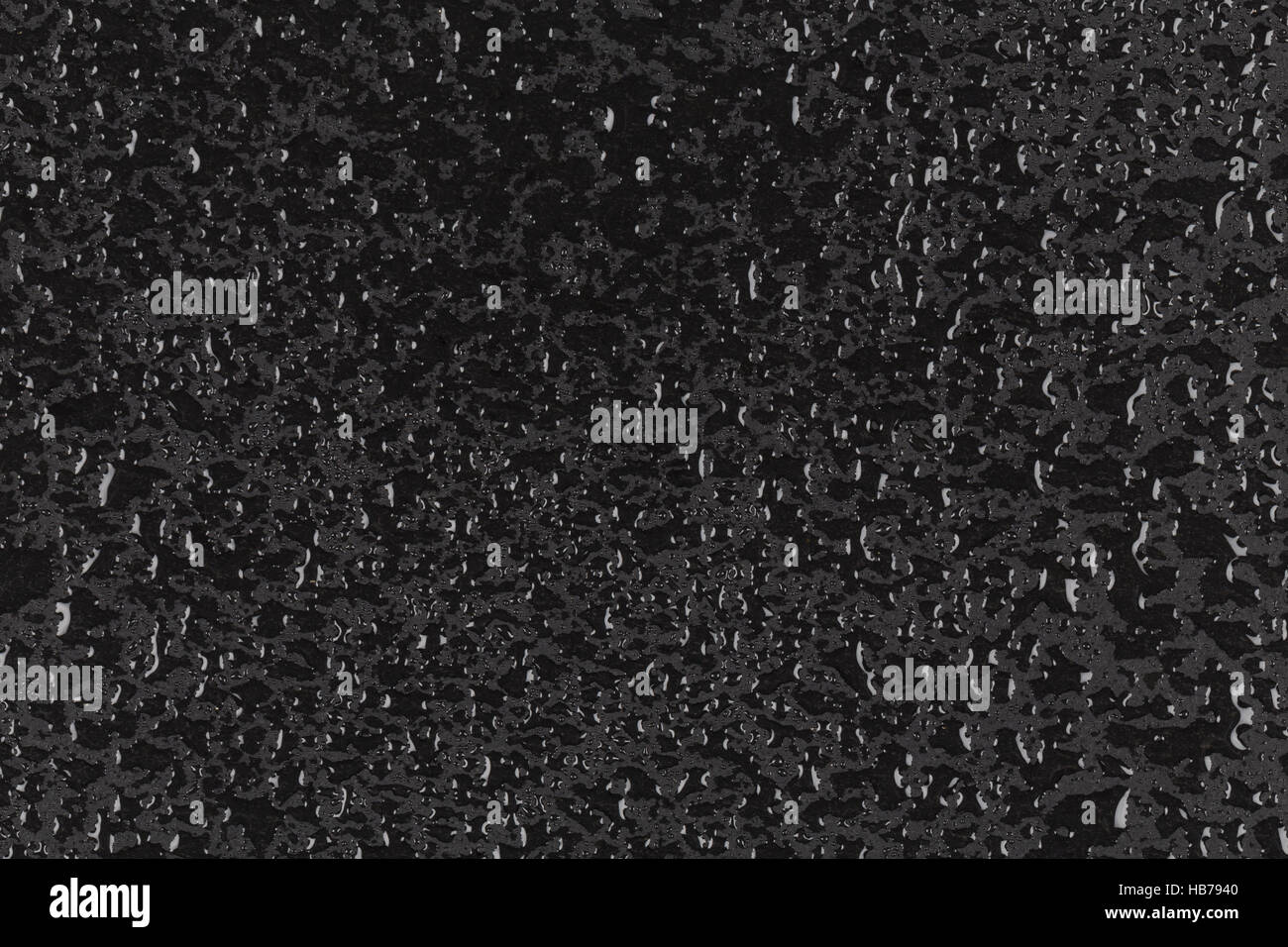 Water drops on dark stone rock surface of basalt or granite Stock Photo ...