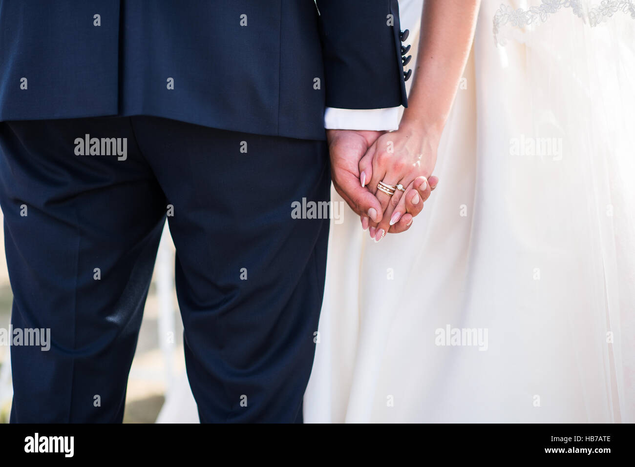 Hand in hand of wedding couple Stock Photo - Alamy