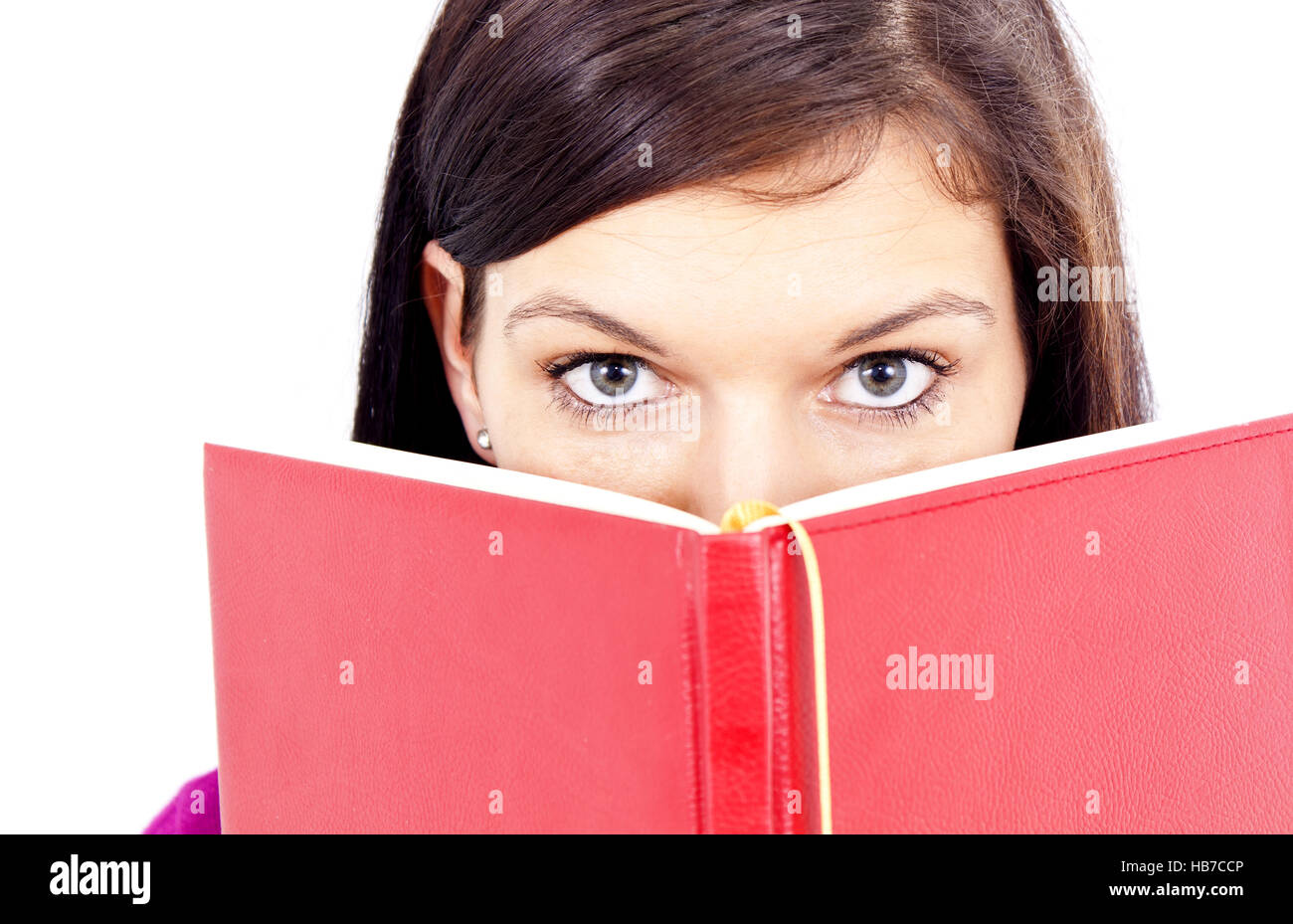 Beautiful girl reading from a dig book Stock Photo - Alamy