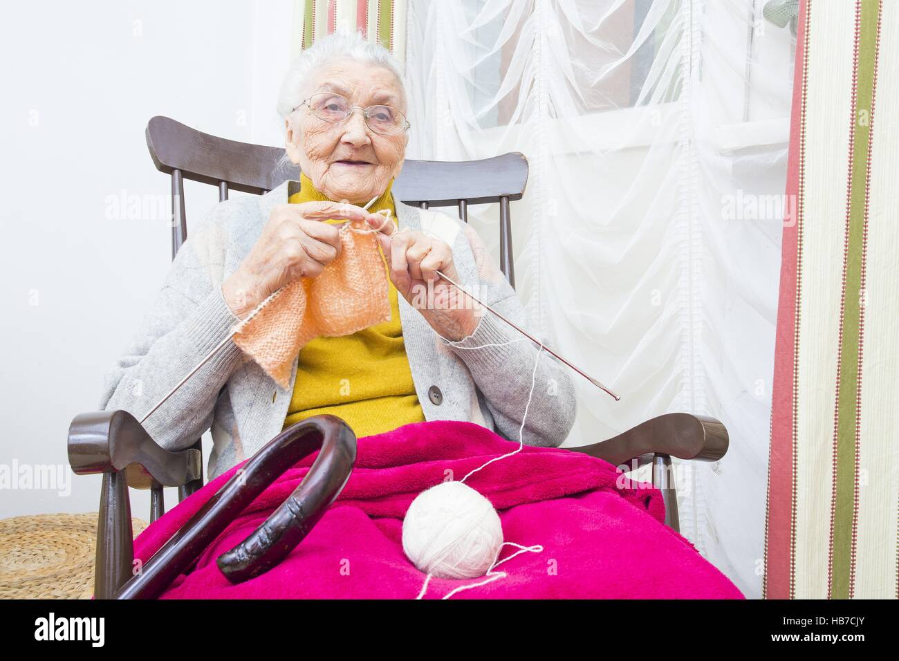 Elderly lady relaxing while doing her hobby - knitting Stock Photo - Alamy