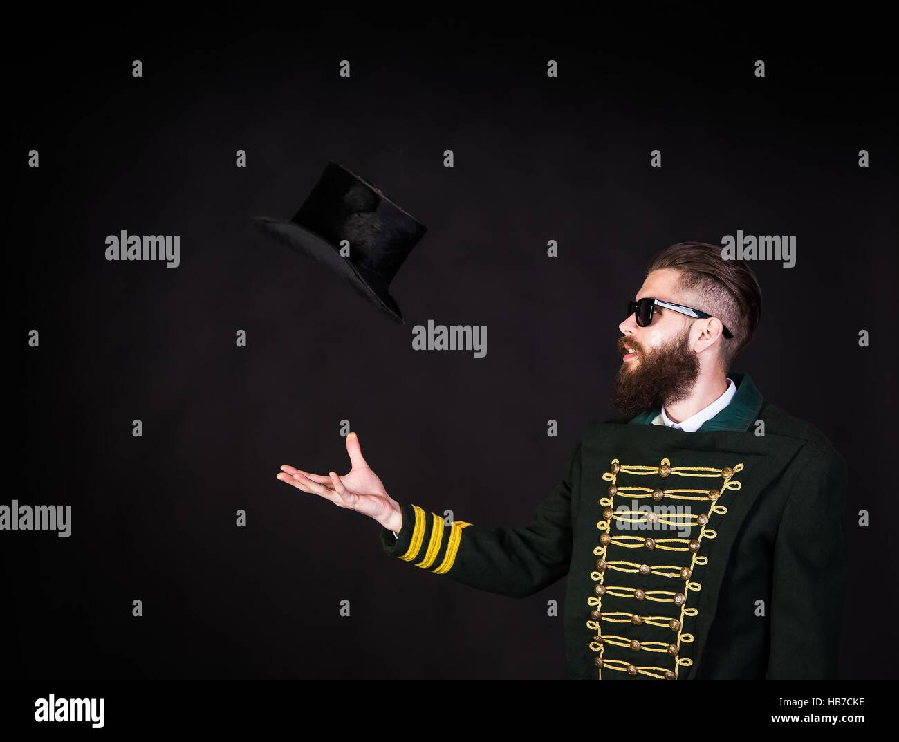 Magician throwing hat up in the air Stock Photo - Alamy