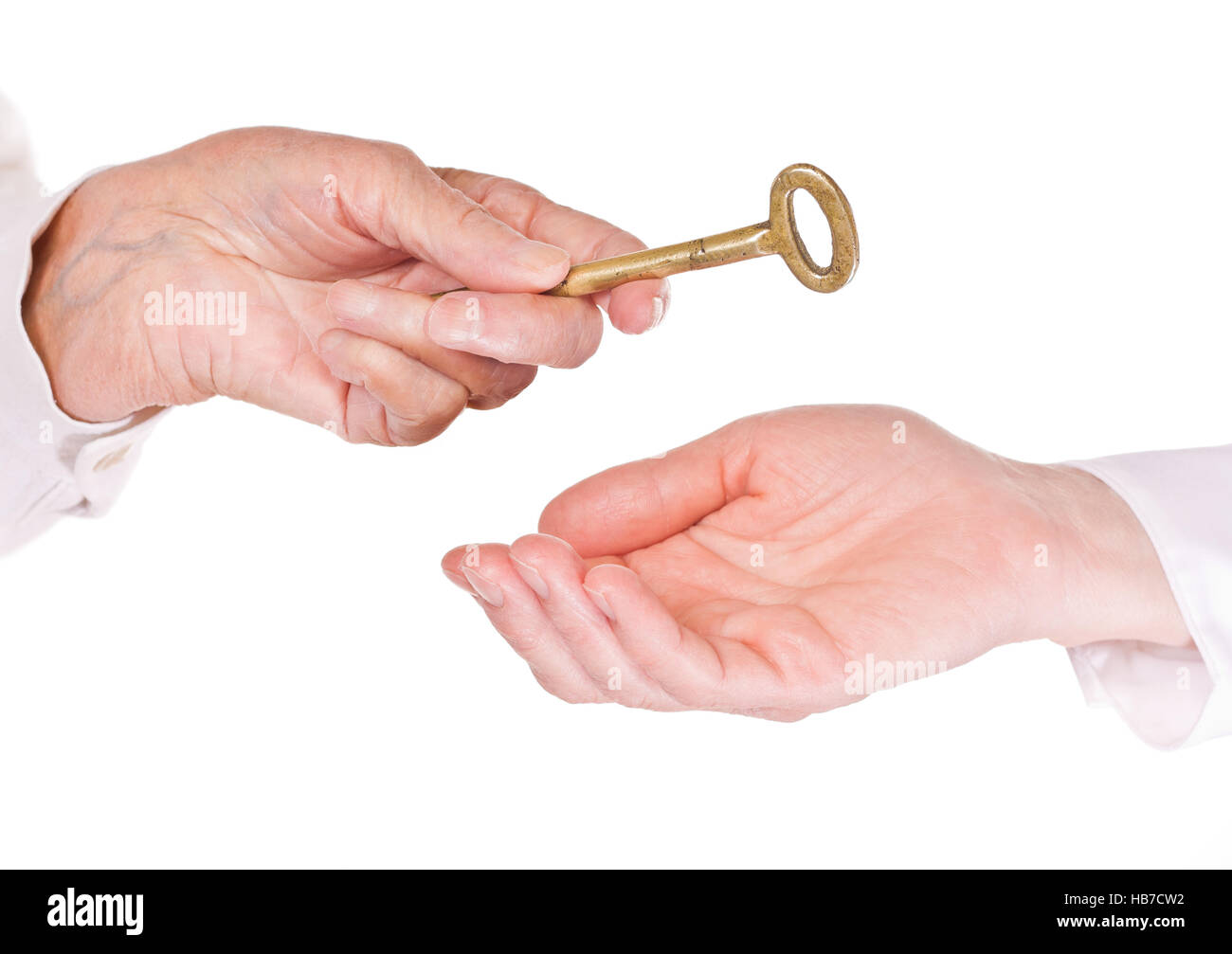 Old woman handing keys to younger woman Stock Photo - Alamy