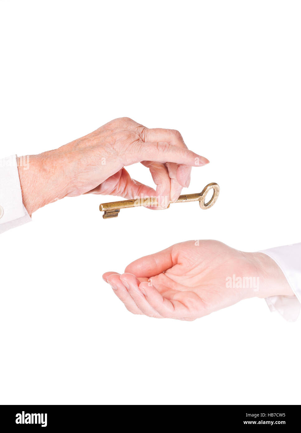 Old woman handing keys to younger woman Stock Photo - Alamy