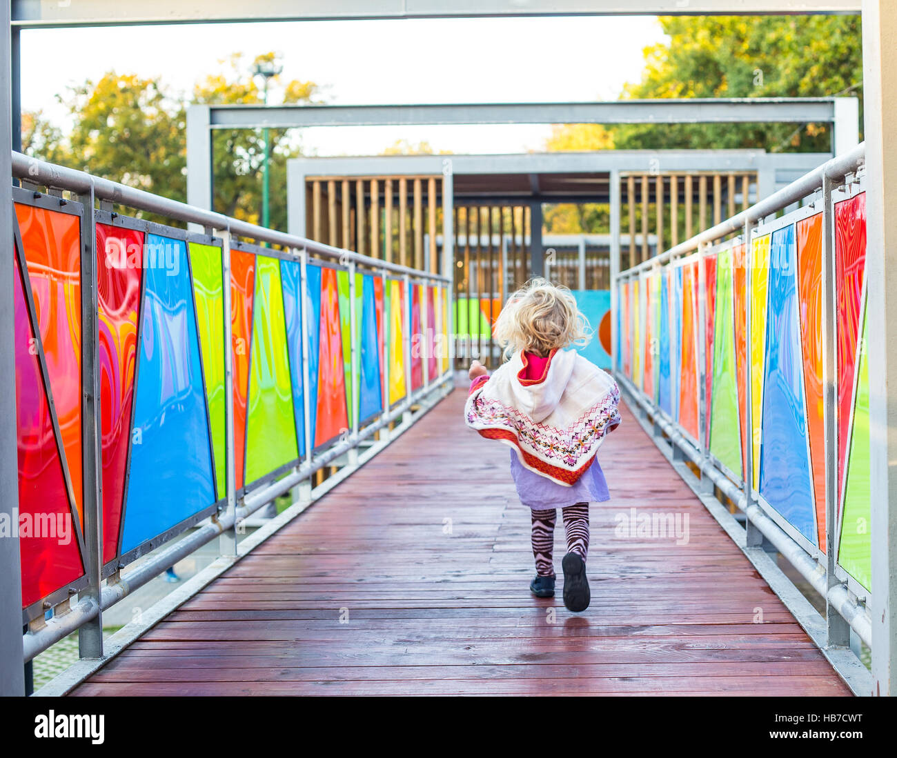 Happy little child running in the playground Stock Photo - Alamy