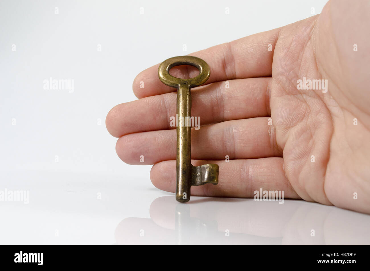 Hand holding key Stock Photo - Alamy