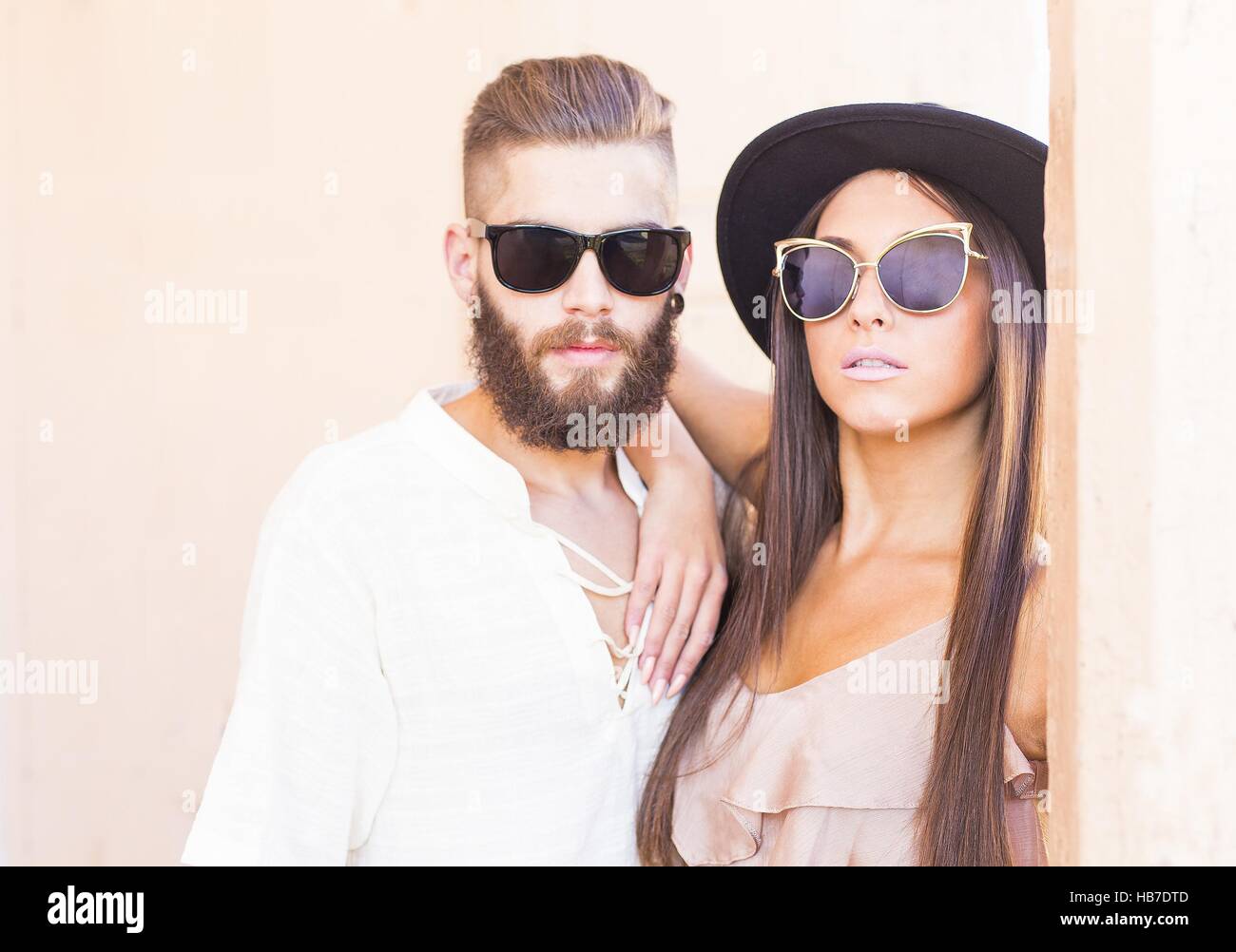 Two elegant hipster people in sunglasses posing Stock Photo - Alamy