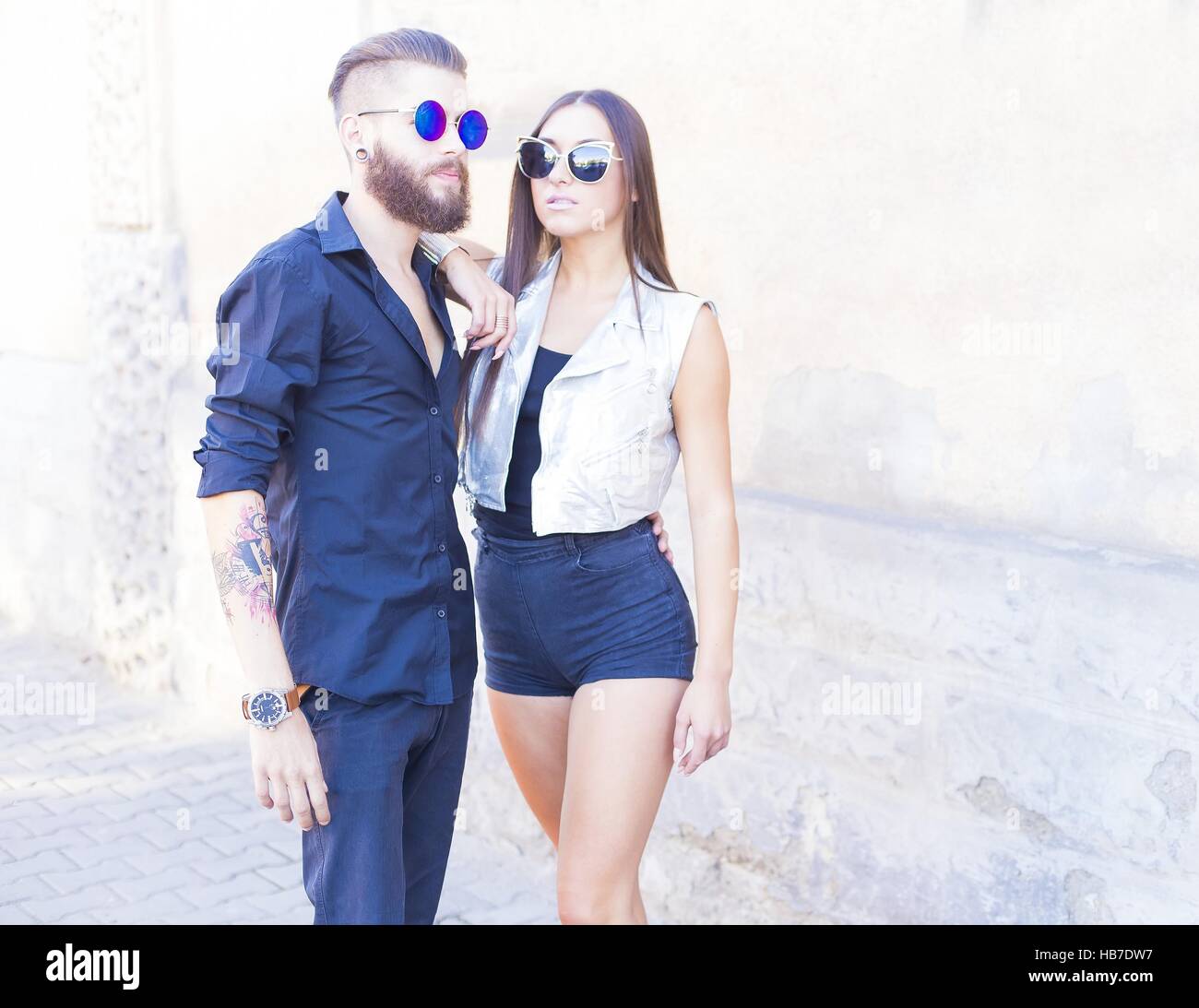 Two elegant hipster people in sunglasses posing Stock Photo - Alamy