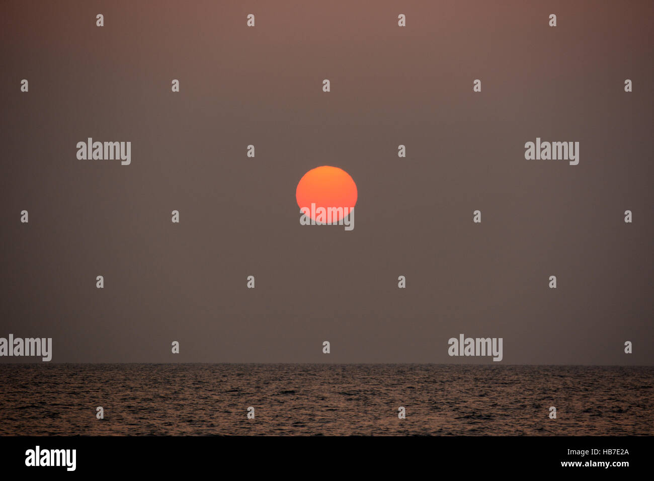 Simply beautiful two-tone image featuring a globe of sun mid-picture in ...