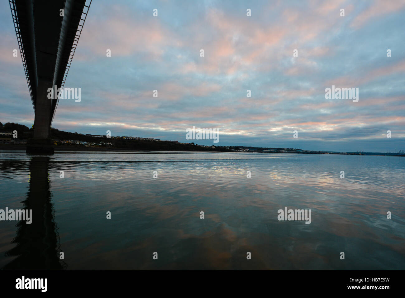 The Cleddau bridge at Pembroke Dock silhouetted against the pink and ...