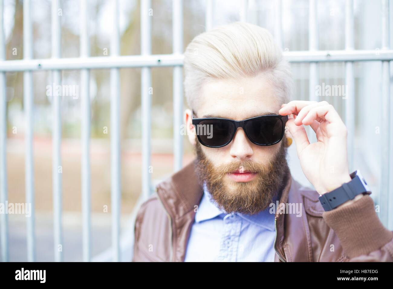 Stylish young hipster guy showing off with cool hand gestures Stock ...