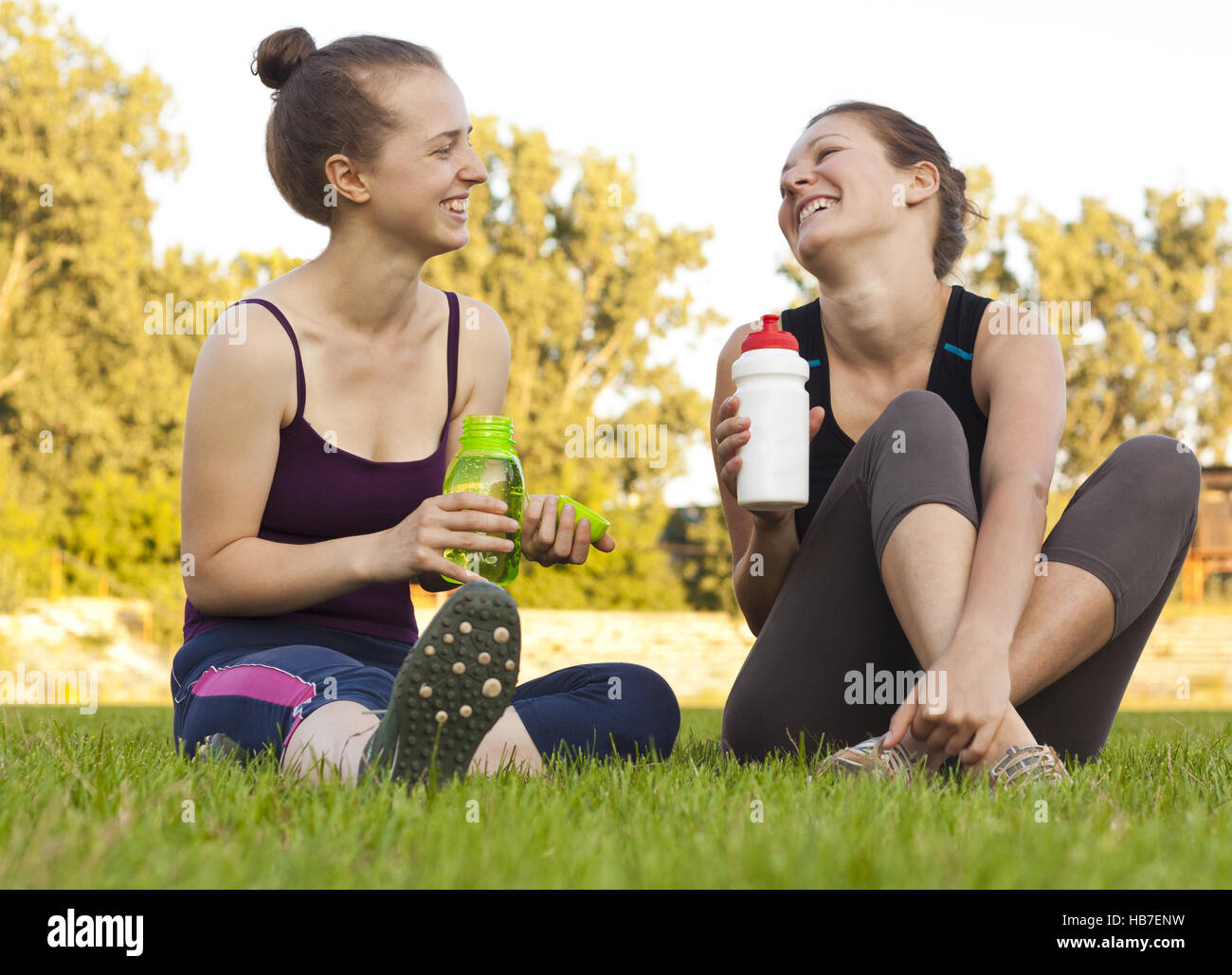 Two girls having a rest, drinking Stock Photo - Alamy
