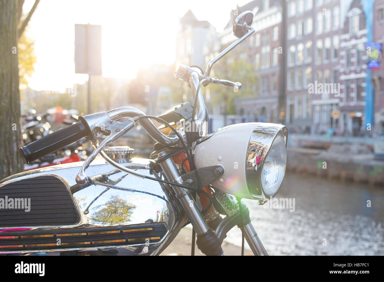 Beautiful motorcycle in the sunset with urban background Stock Photo ...