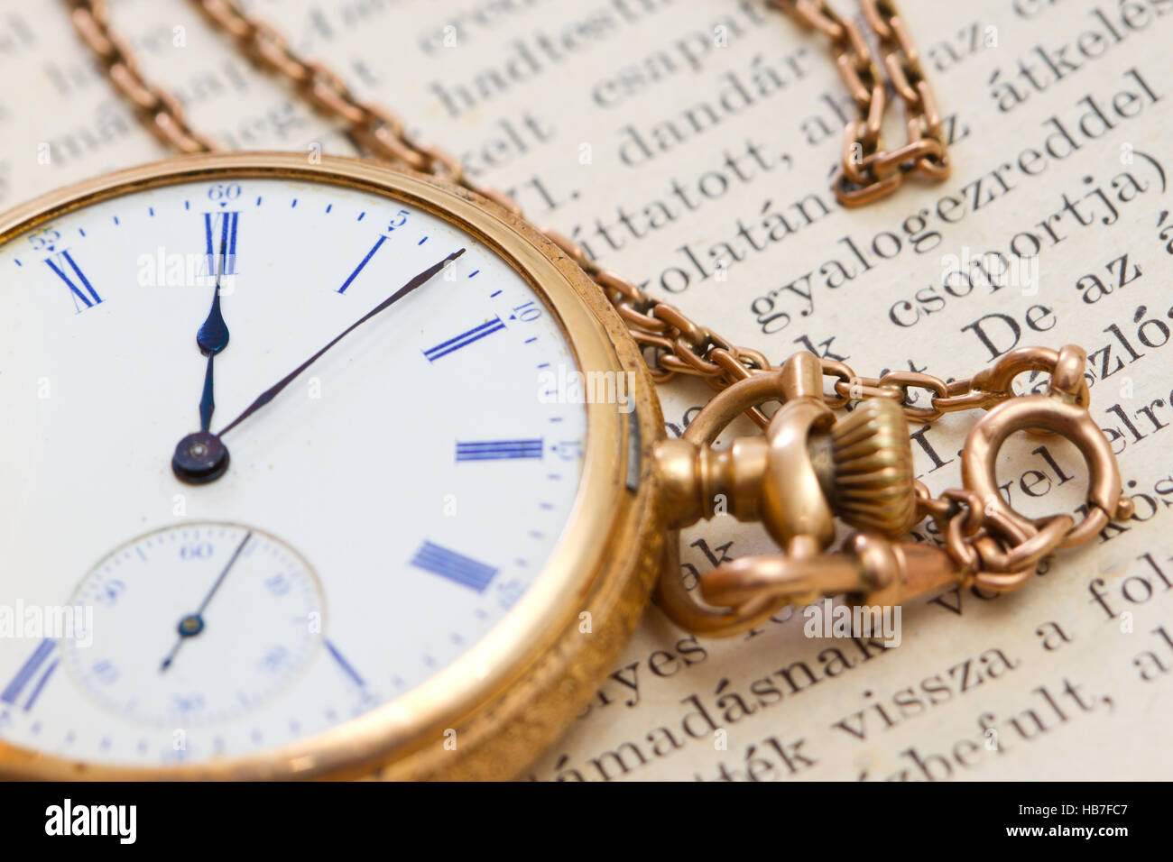 vintage pocket watch on an book Stock Photo - Alamy