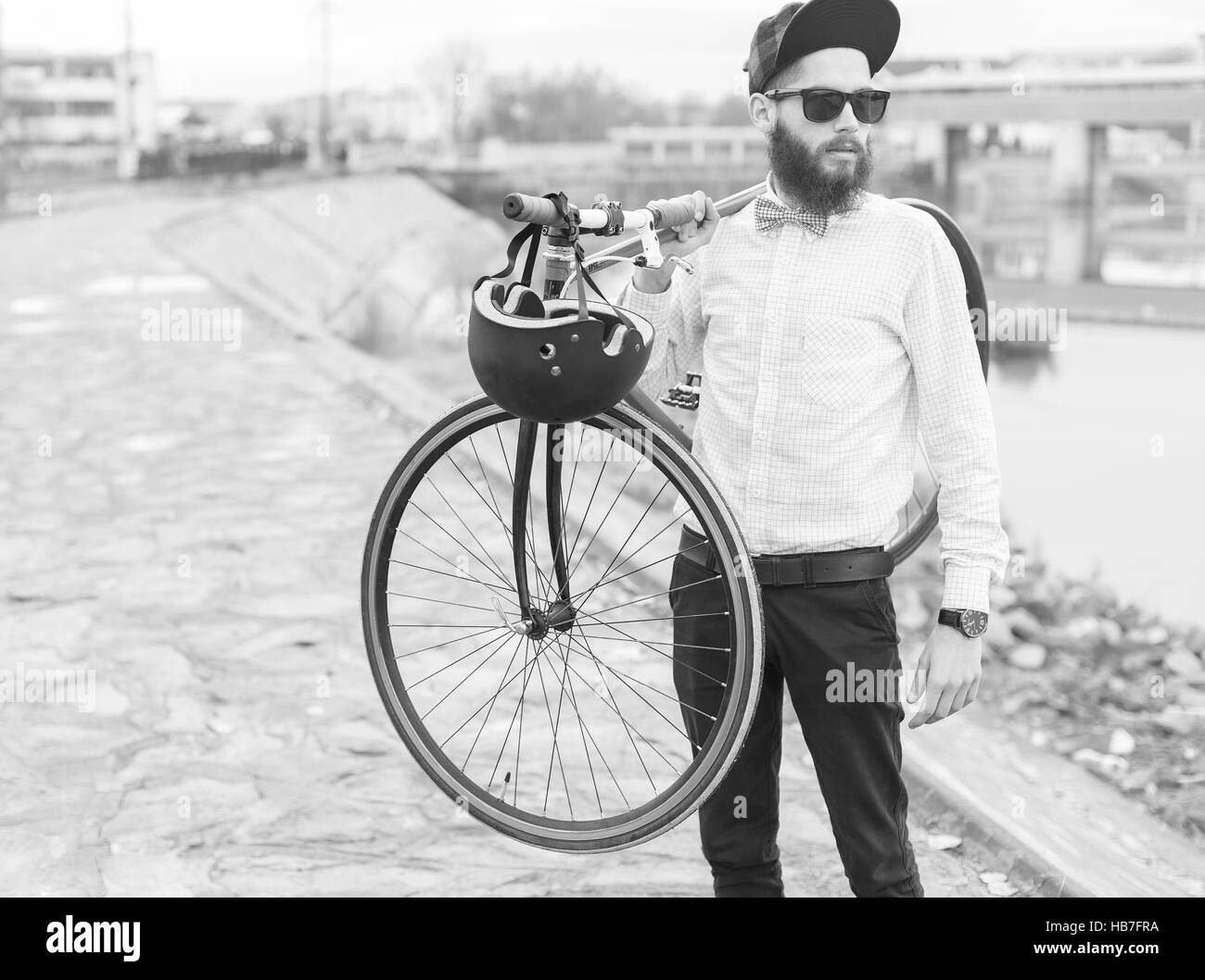 Stylish hipster guy posing with his bicycle - black and white ...