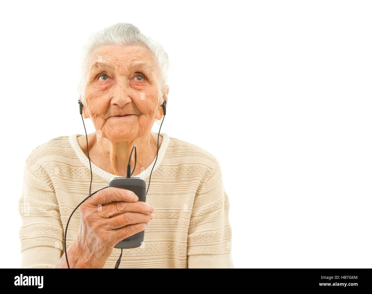 very old lady isolated on white listening to music on the phone Stock ...
