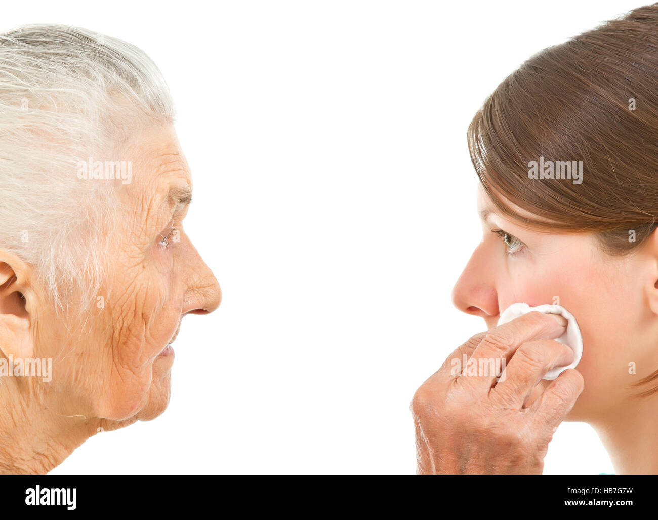 old woman wiping off the face of a young one with a makeup pad Stock ...