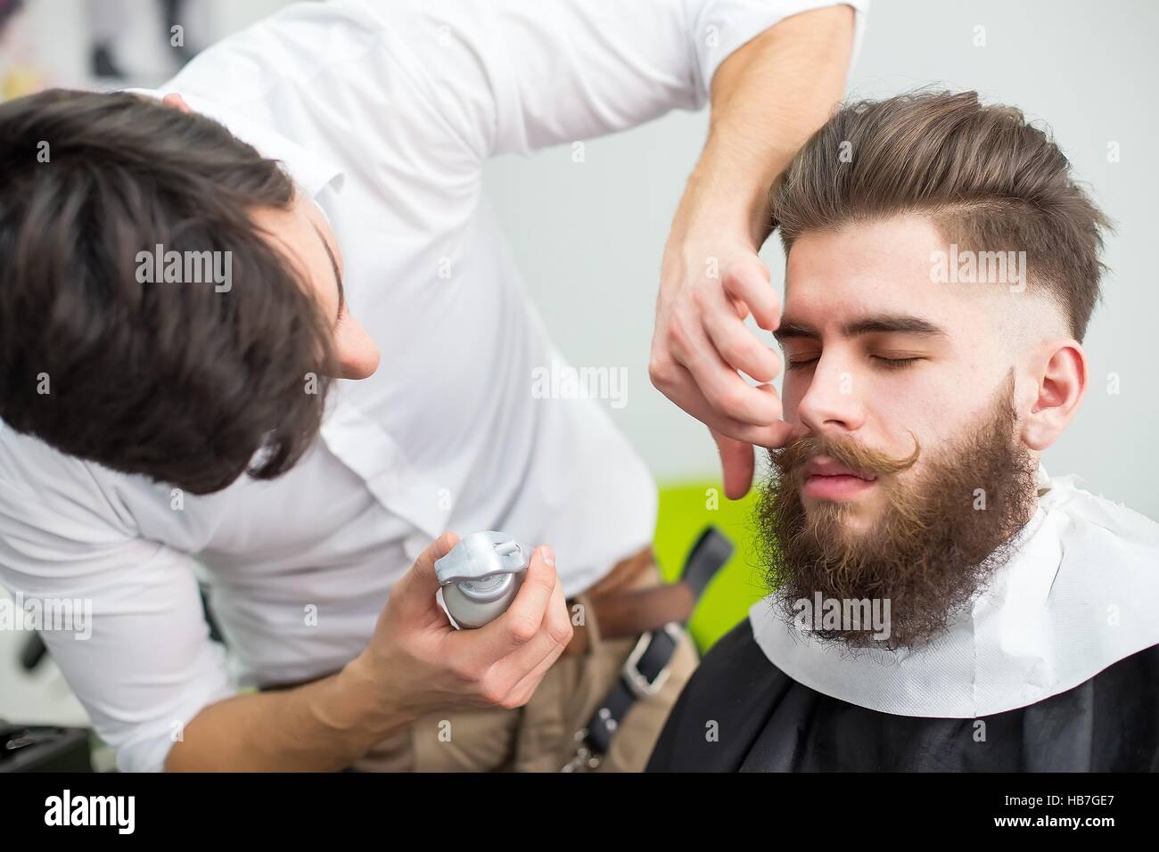 Hipster guy getting his mustache ready for the shooting Stock Photo - Alamy