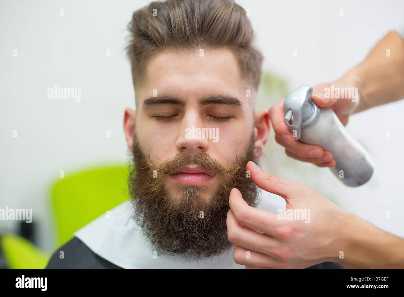 Hipster guy getting his mustache ready for the shooting Stock Photo - Alamy