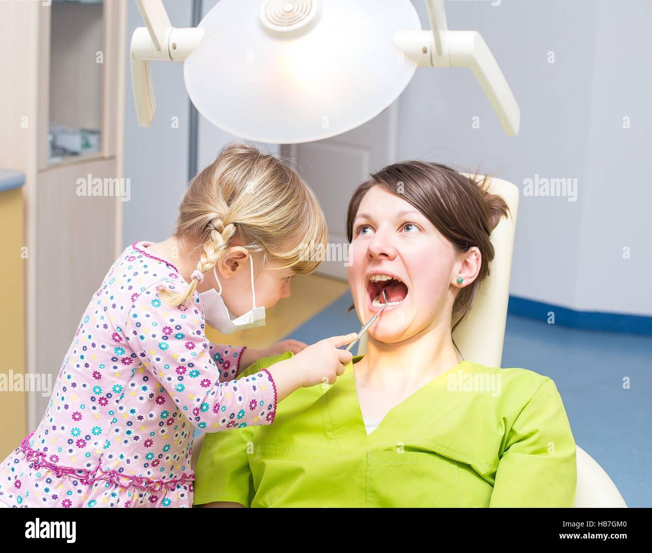 Future doctor checking mother's denture at the dental office Stock ...