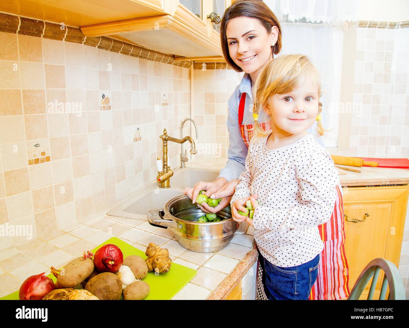Pretty ladies in the kitchen cooking together Stock Photo - Alamy