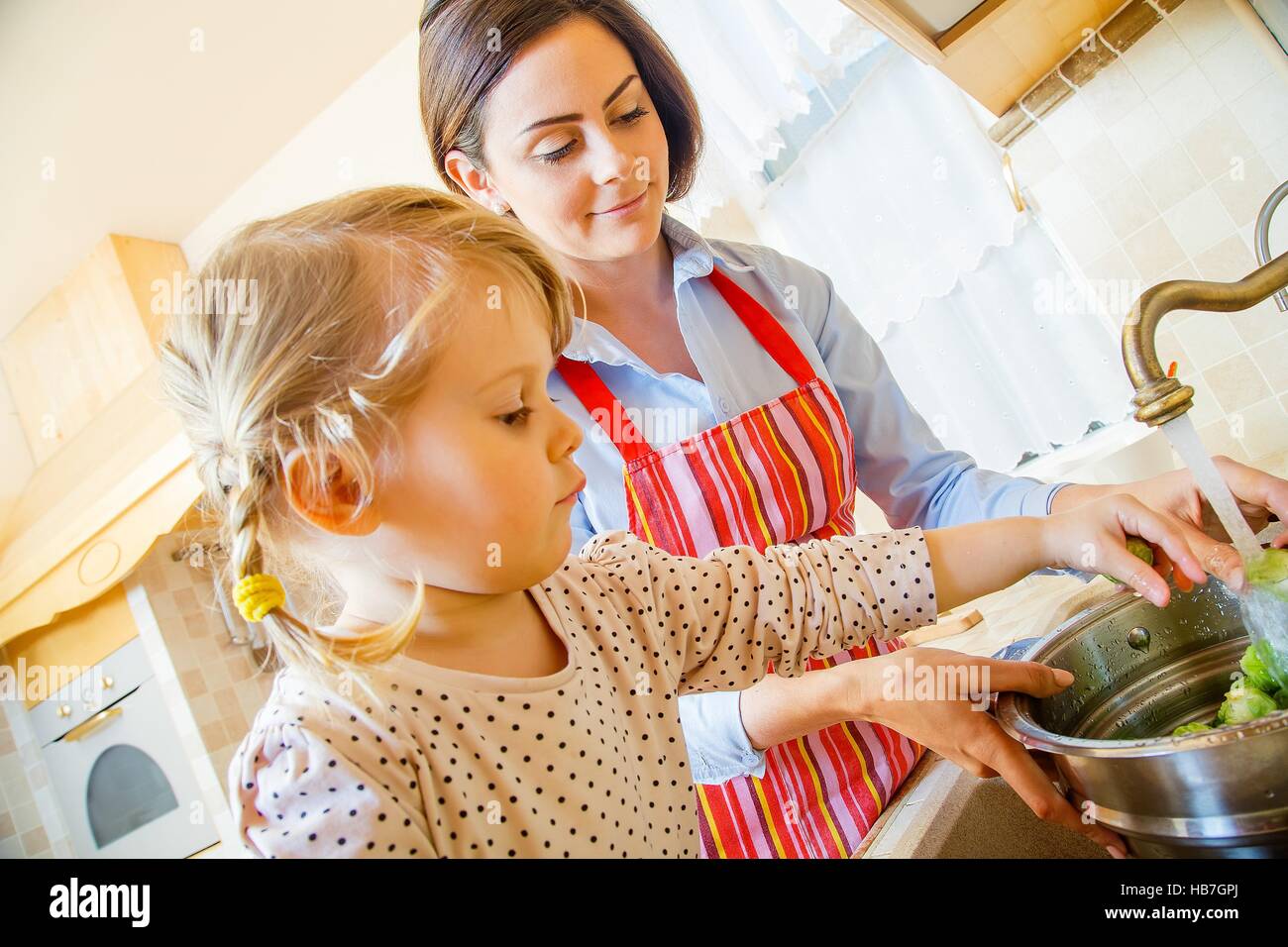 Helping hand given from little blond girl Stock Photo - Alamy