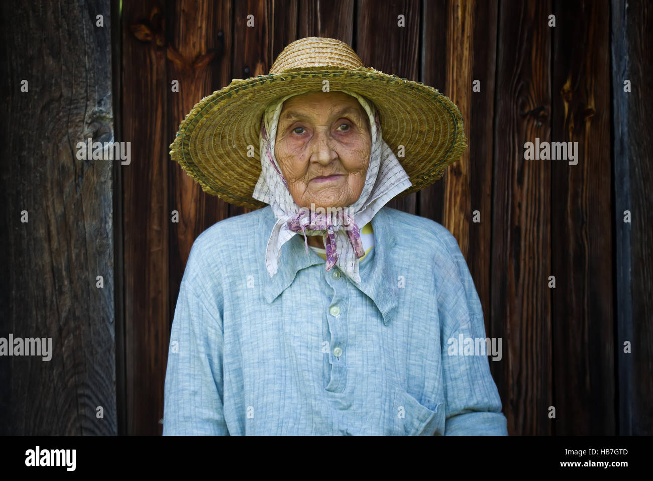 very old woman from village in front of a wooden background Stock Photo ...