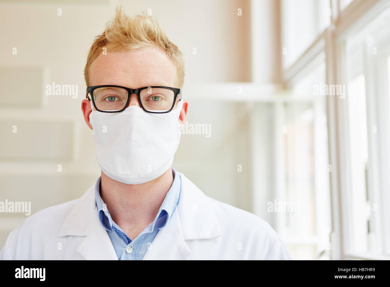 Doctor with hygenic surgical mask as sanitary protection Stock Photo ...