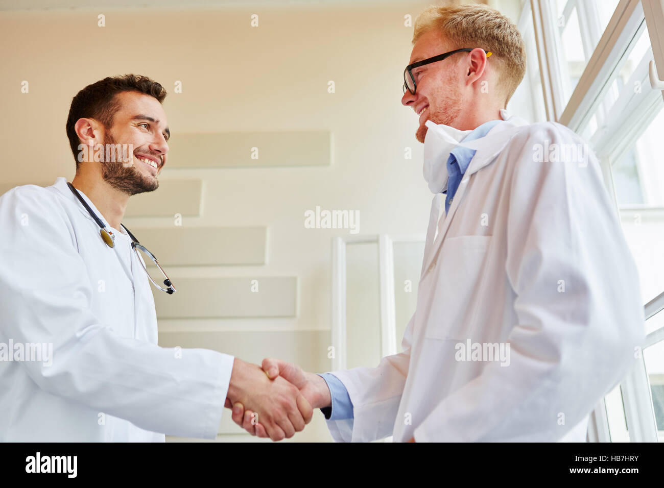 Doctors sharing handshake at hospital Stock Photo - Alamy