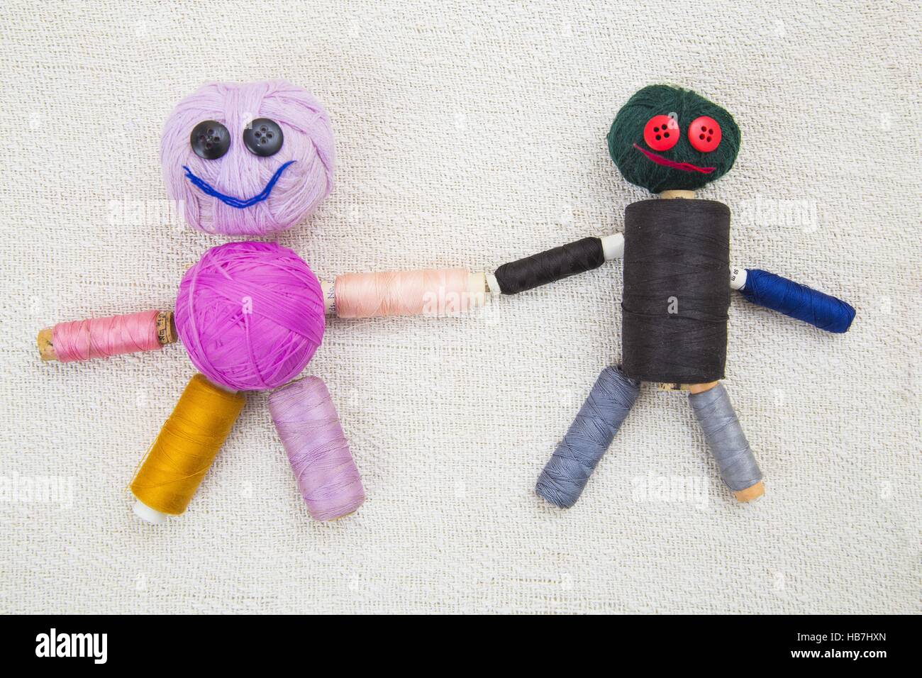 Thread couple holding hands and smiling - love concept Stock Photo - Alamy