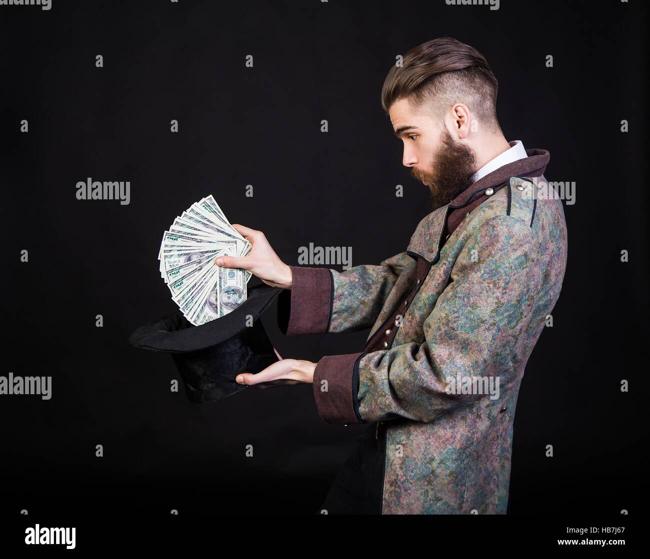 Man pulling out money from a magical hat Stock Photo - Alamy