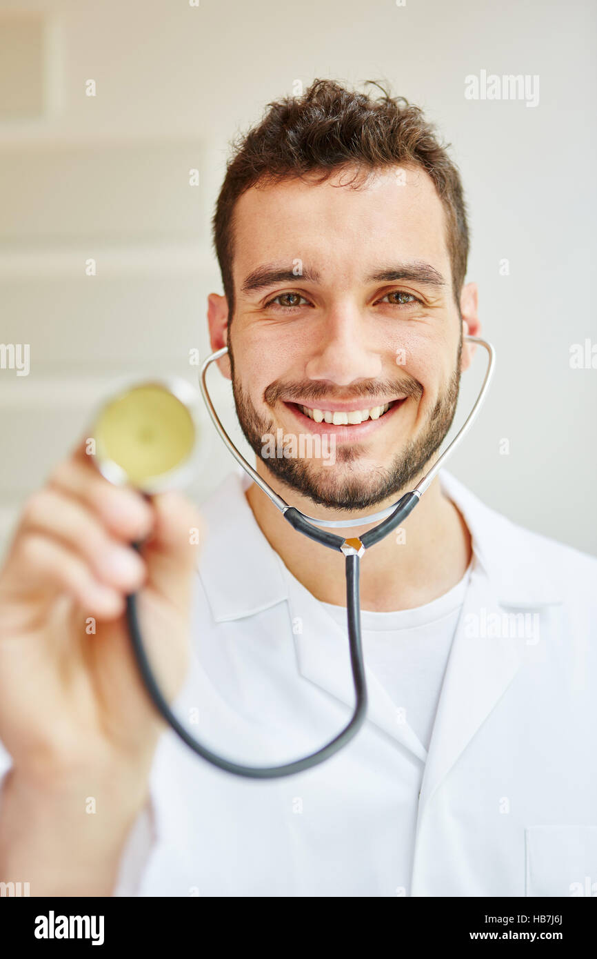 Physician with stethoscope smiling friendly Stock Photo - Alamy