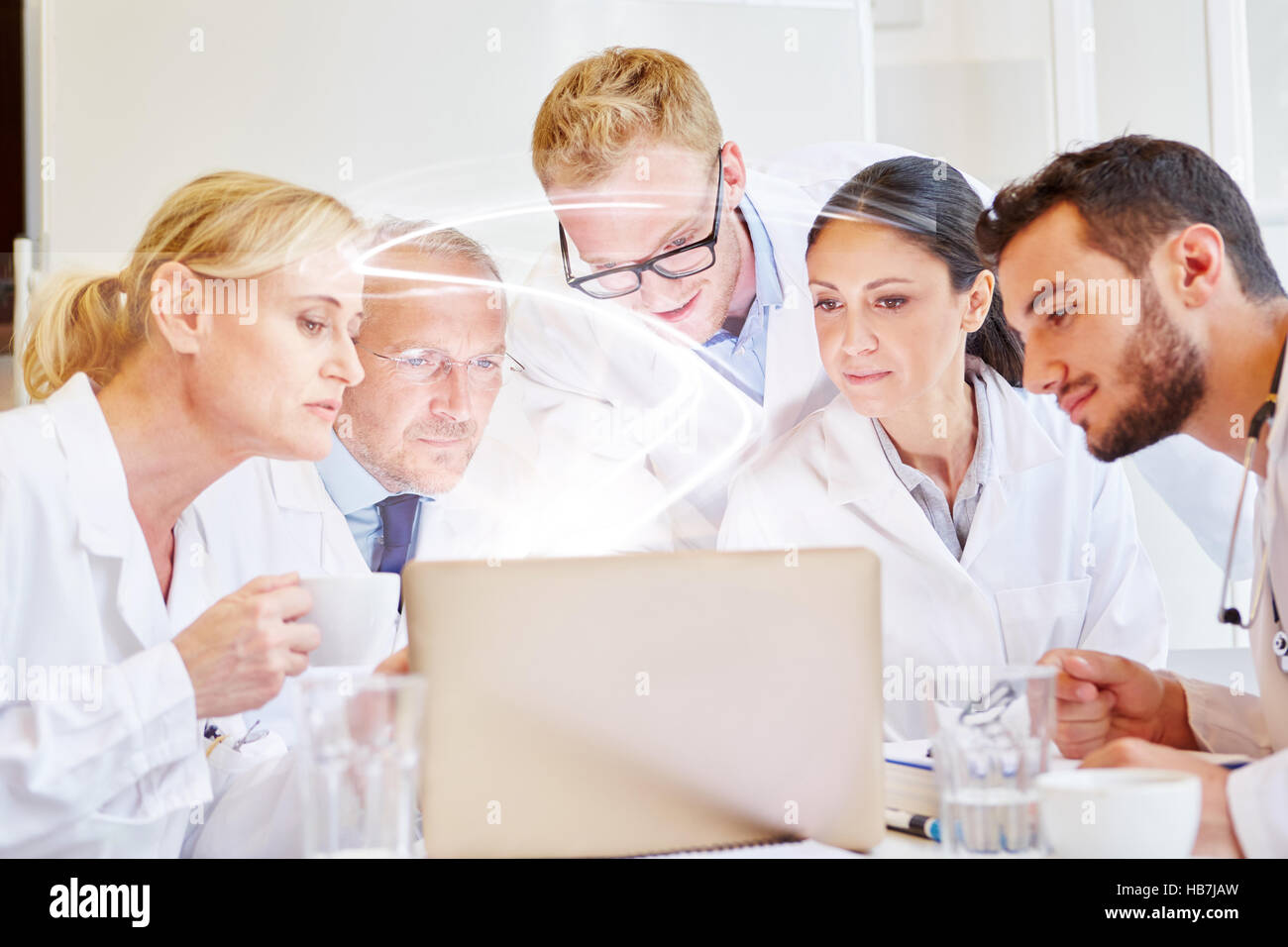 Team of doctors working with computer with light beam in hospital Stock ...