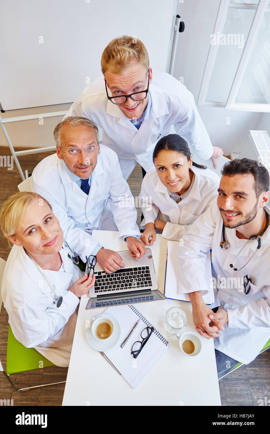 Successful group of doctors as a team in meeting at medical clinic ...