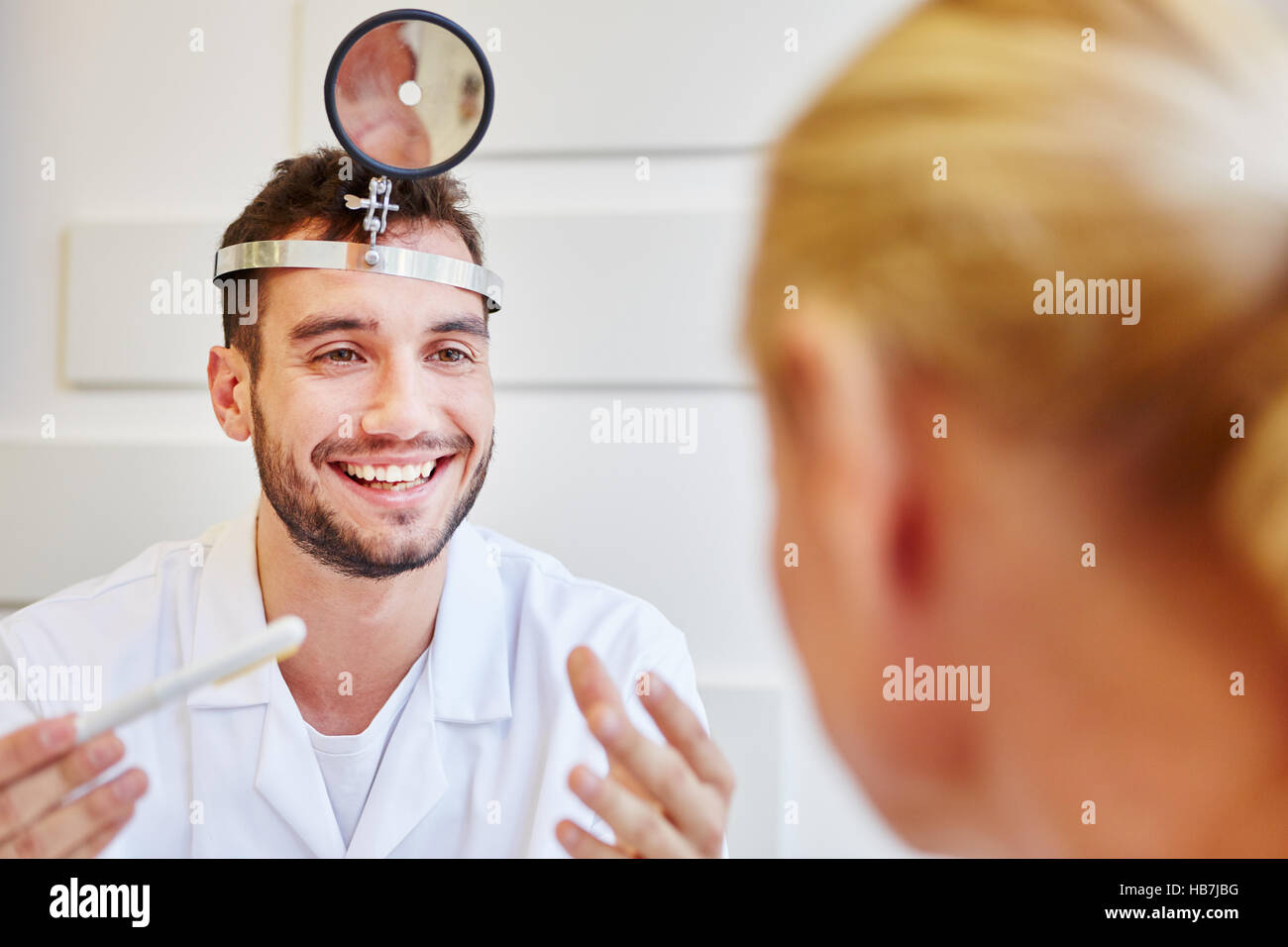 Friendly ENT physician in consultation talking to patient Stock Photo ...