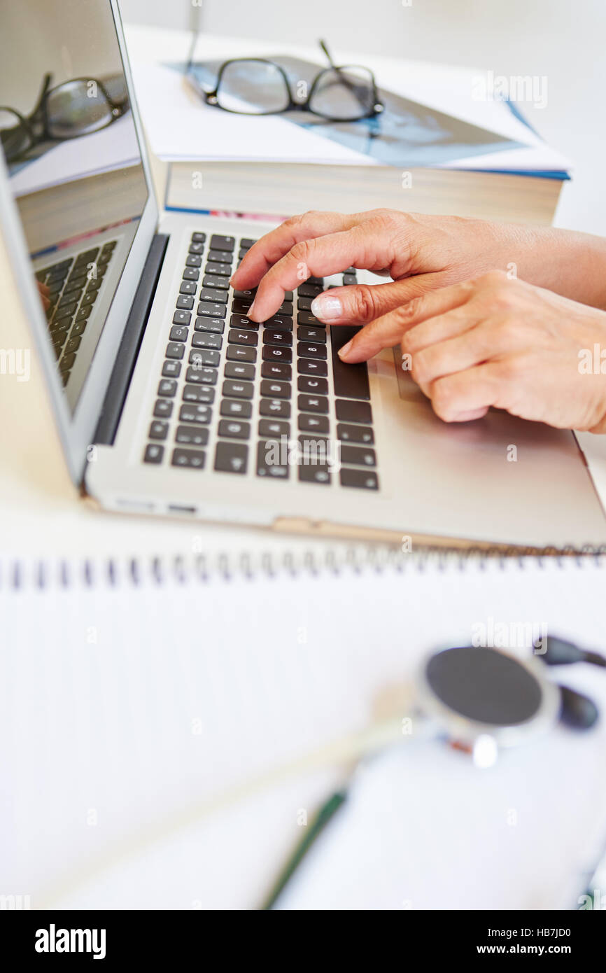Laptop at office of doctor while writing and typing distance study ...