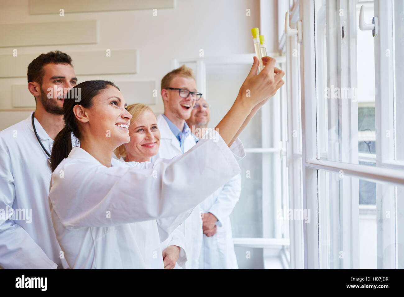 Group of doctors experiment with urine sample in hospital Stock Photo ...