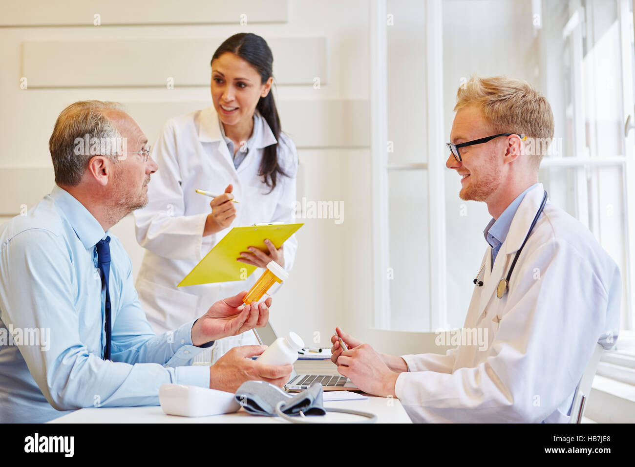 Doctors and patient in consultation giving medicament advice for ...