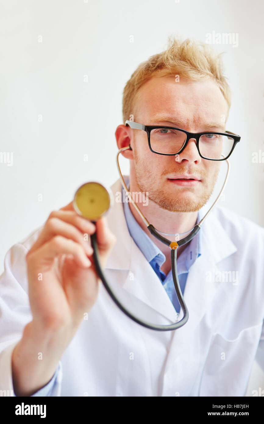 Man as physician with stethoscope to auscultate patients Stock Photo ...