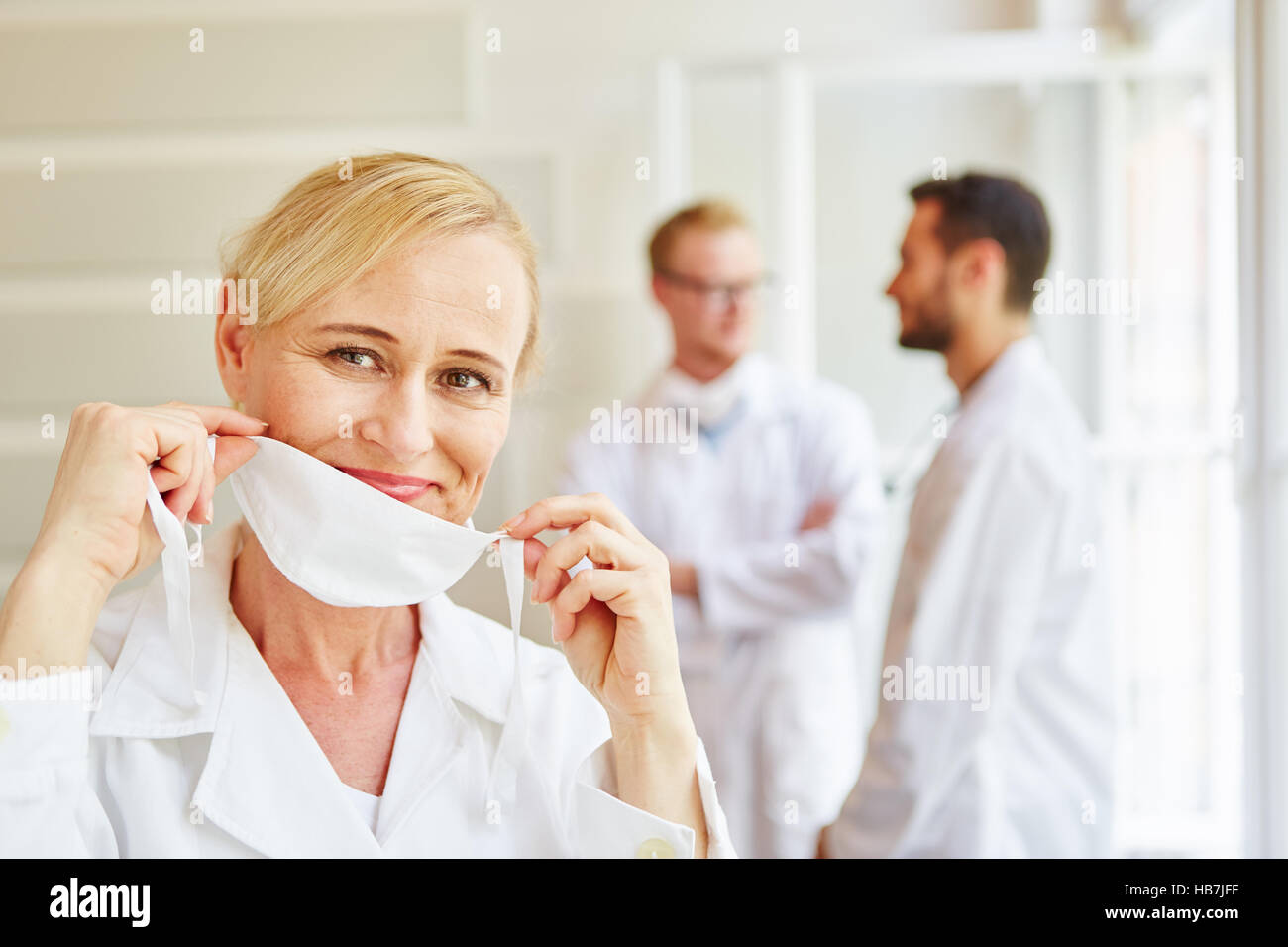 Woman doctor putting surgical mask on getting ready for surgery Stock ...