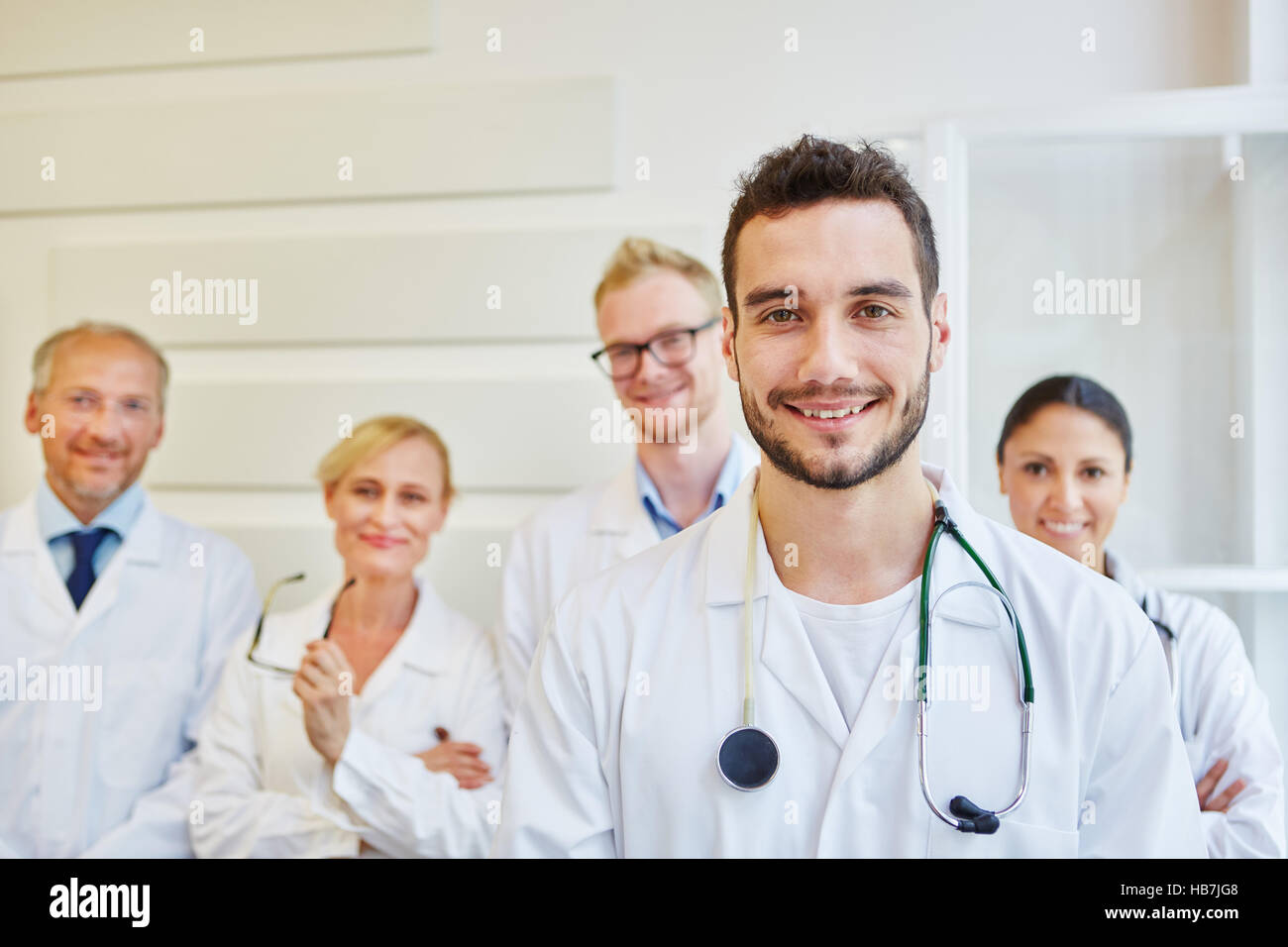 Man as doctor with medical team at hospital Stock Photo - Alamy