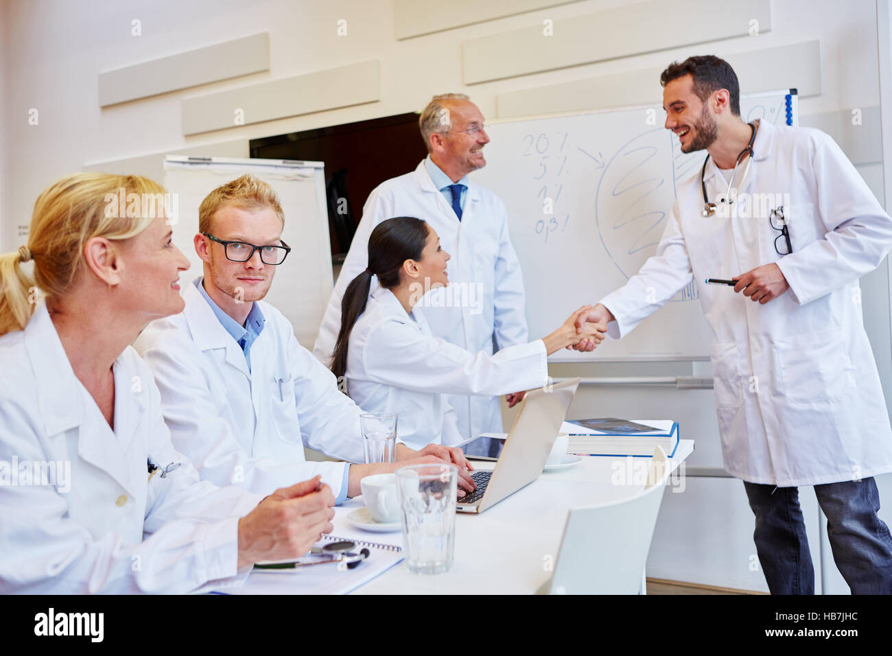 Doctor congratulates student for successful performance Stock Photo - Alamy